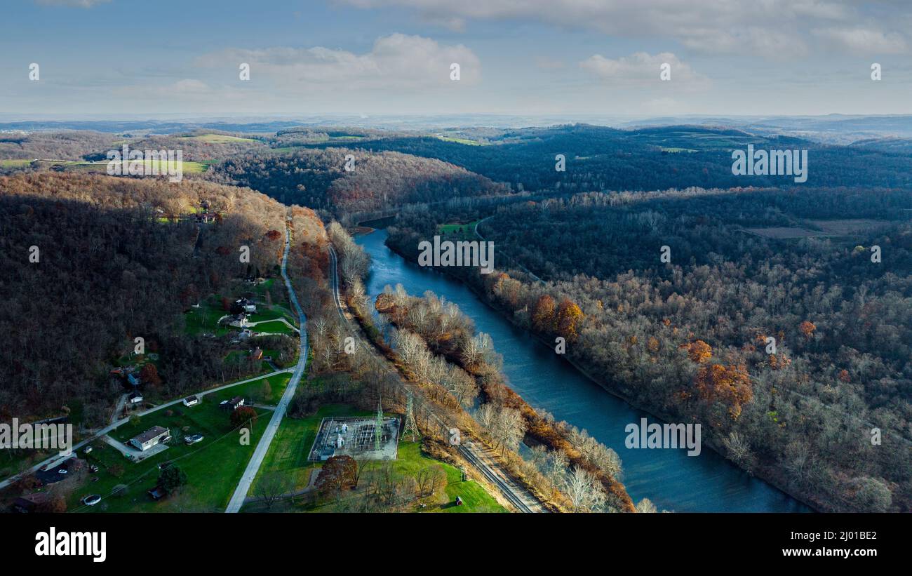 Aerial shot of urban elevated bridges roads over green forest and long ...