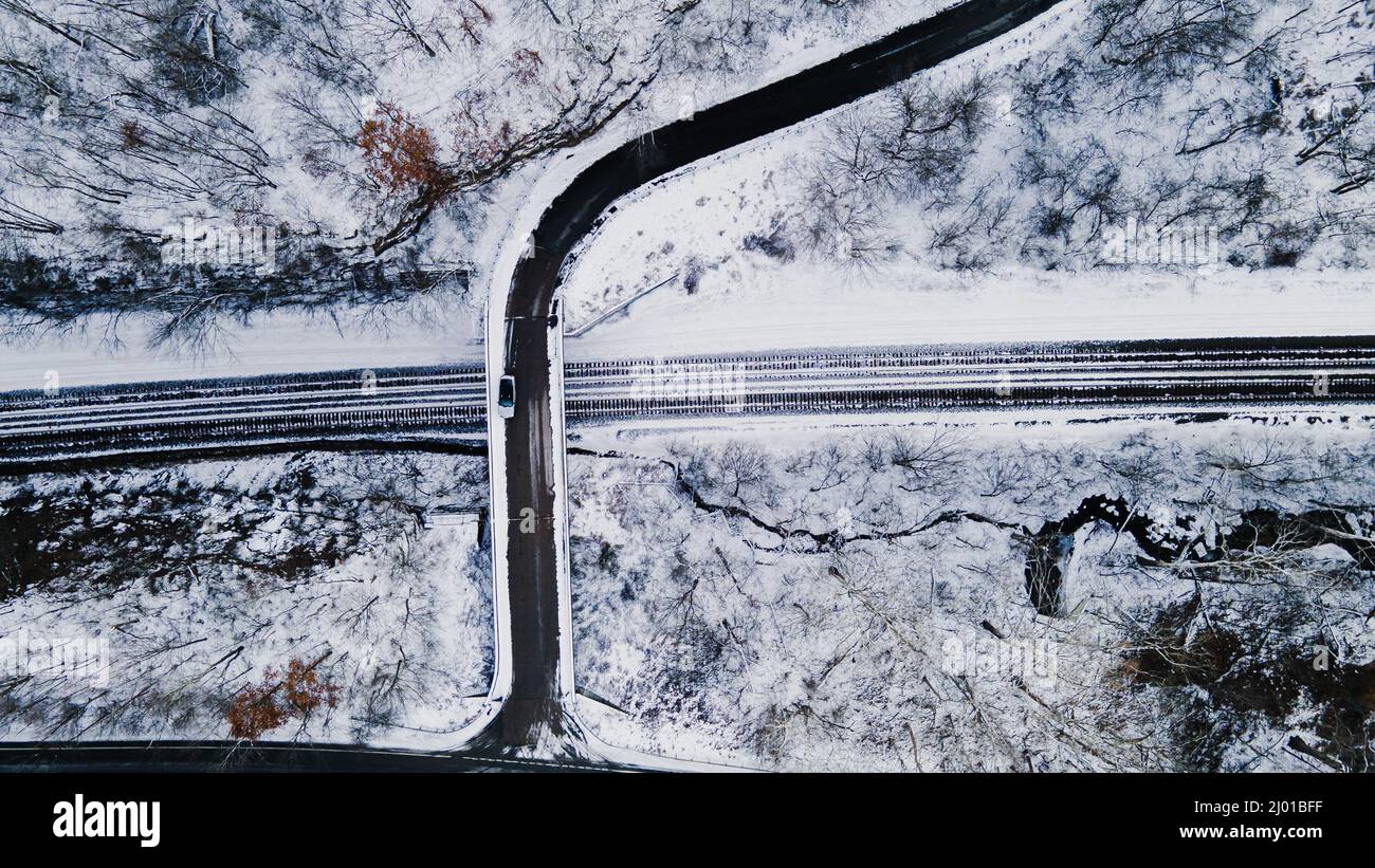 Aerial high angle shot of roads with white snow spaces around on a ...