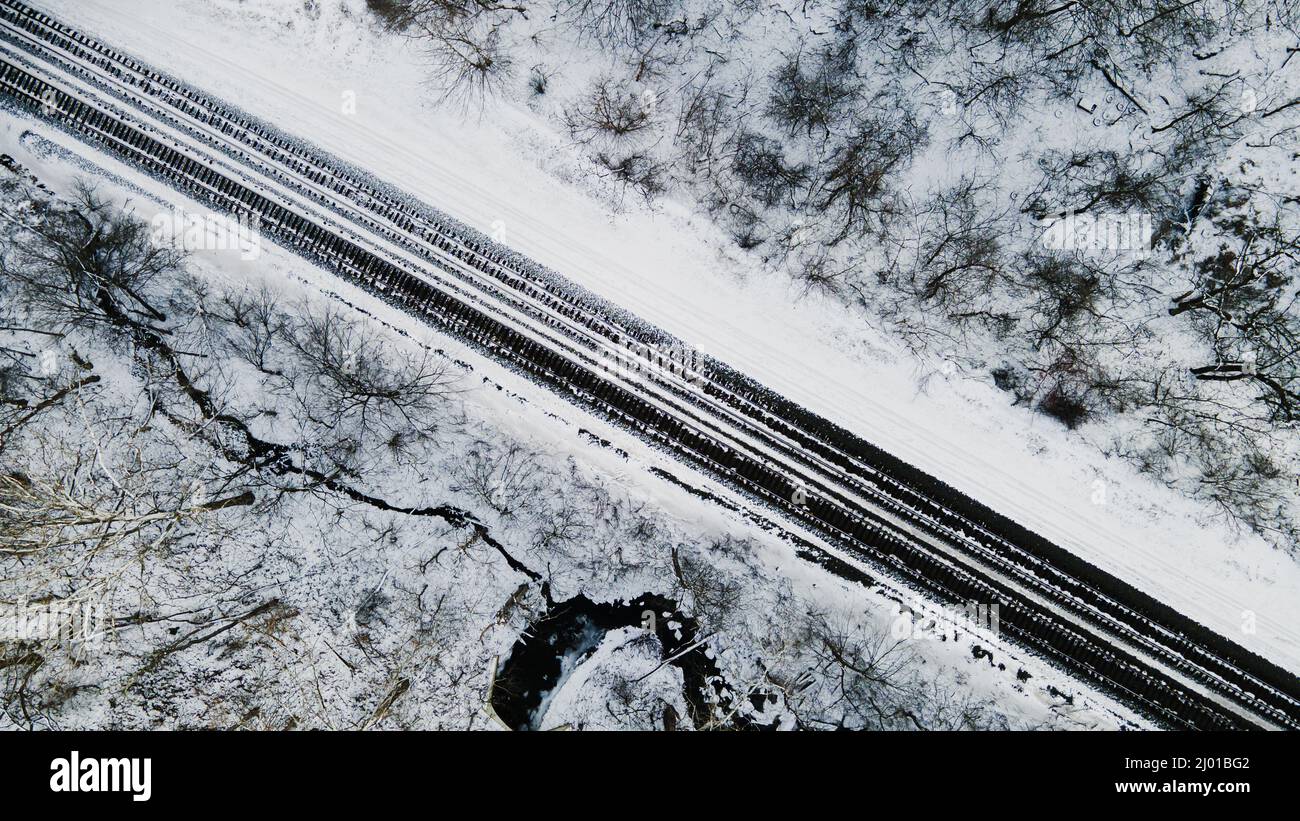 Aerial high angle shot of roads with white snow spaces around on a ...
