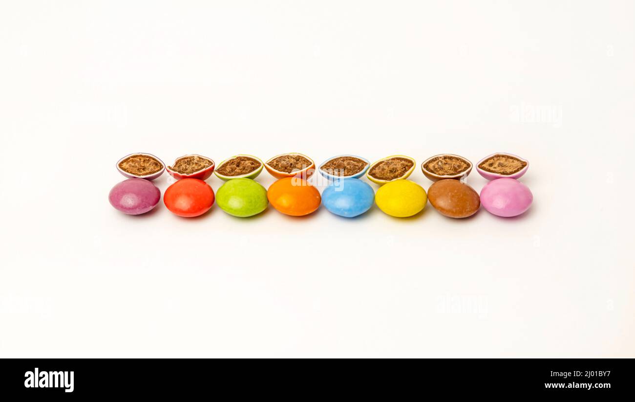Candies of different colors are laid out in the middle on a white ...
