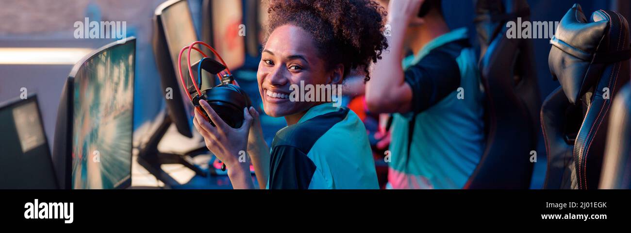 Cute woman gamer getting ready for game in computer club Stock Photo ...