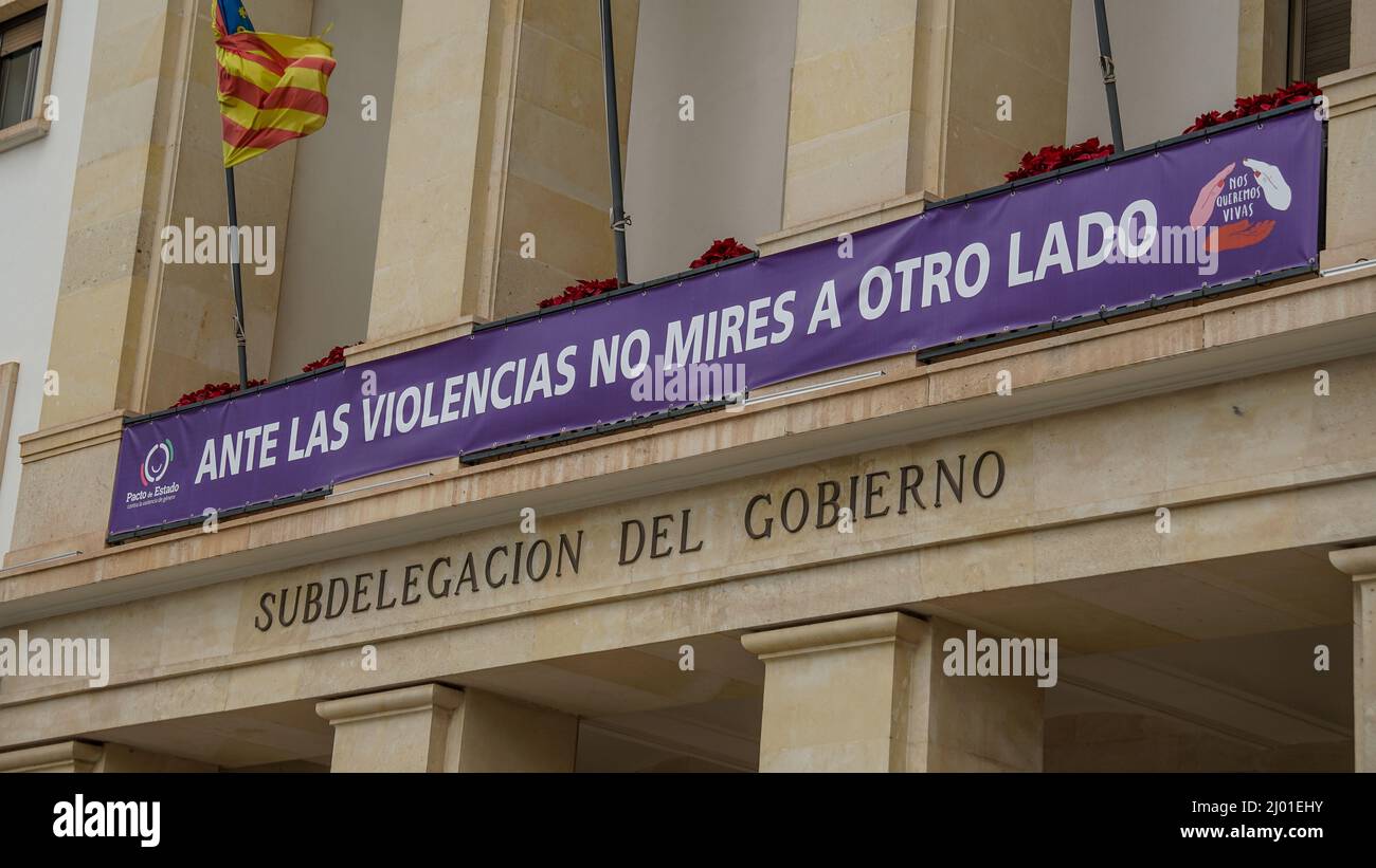 "IN THE FACE OF VIOLENCE, DO NOT LOOK THE OTHER WAY" banner on Alicante ...