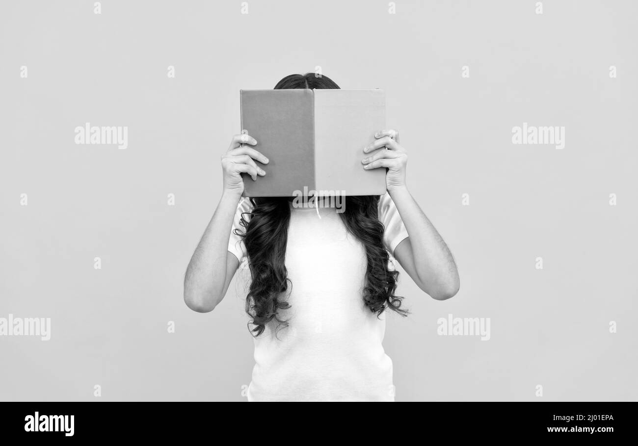 school teen girl ready to study hiding behind copybook, education Stock ...