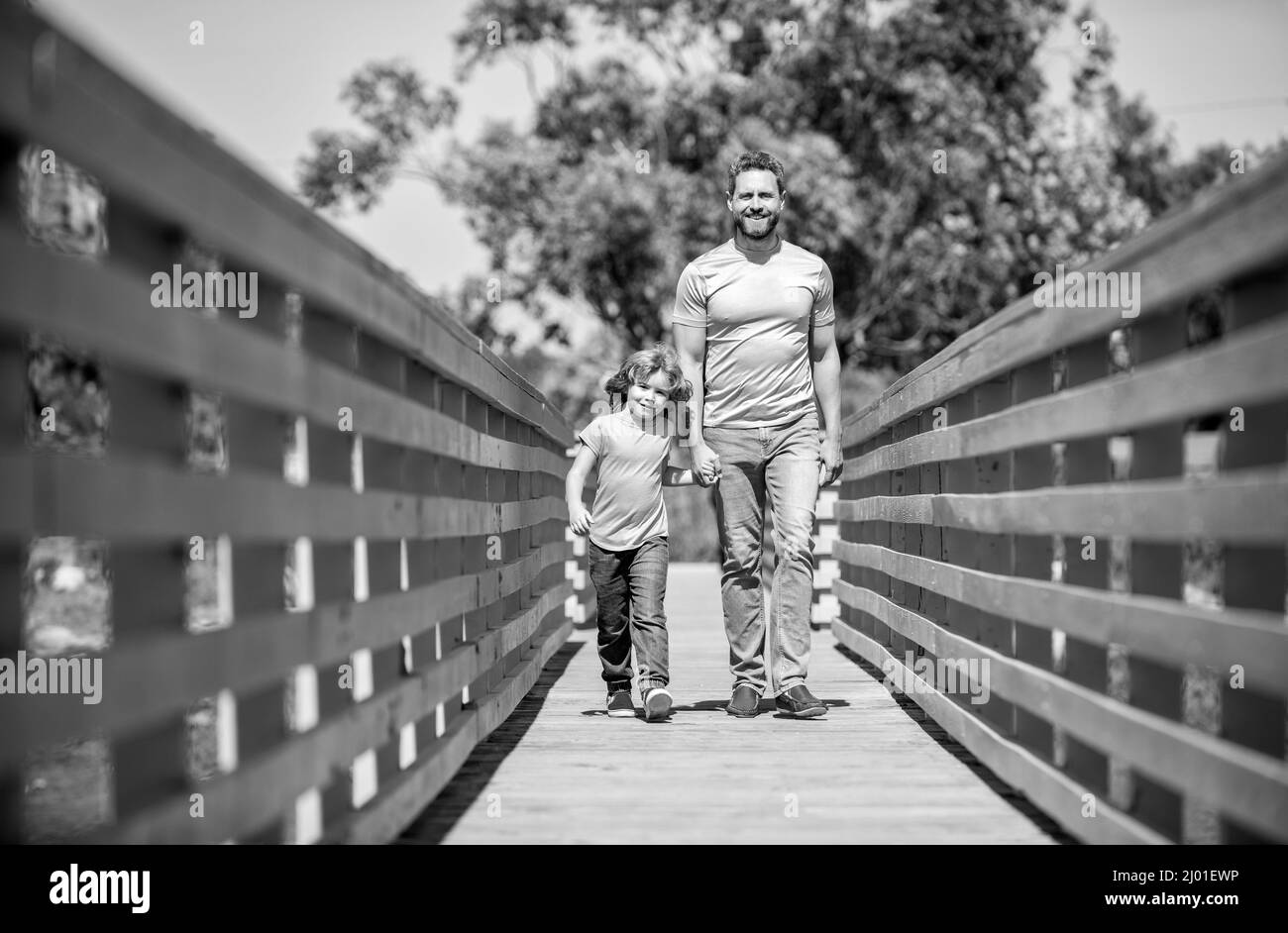 smiling single daddy leading small kid outside, friendship Stock Photo ...