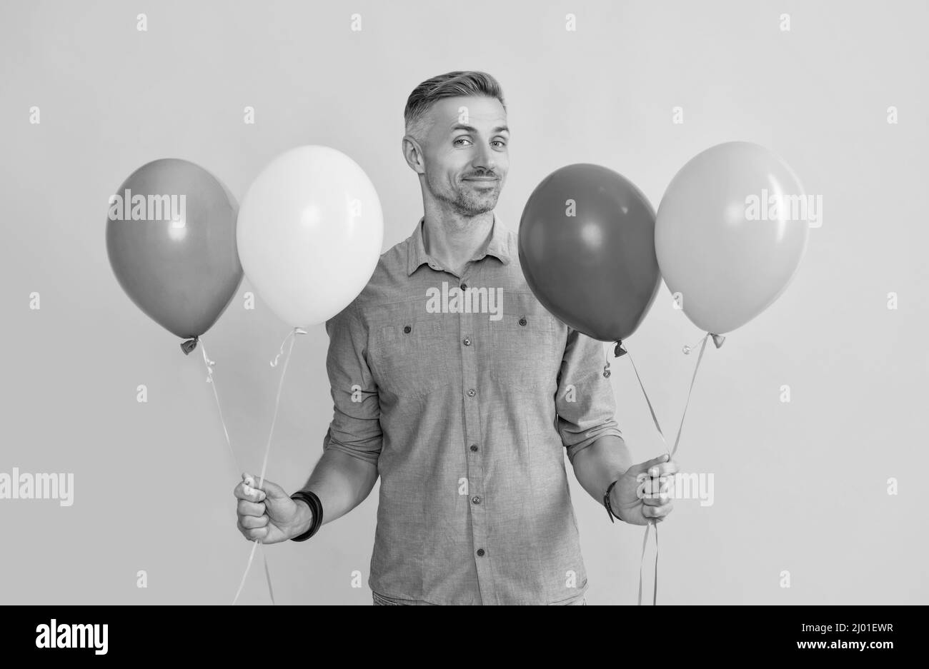 Man holding balloons Black and White Stock Photos & Images - Alamy