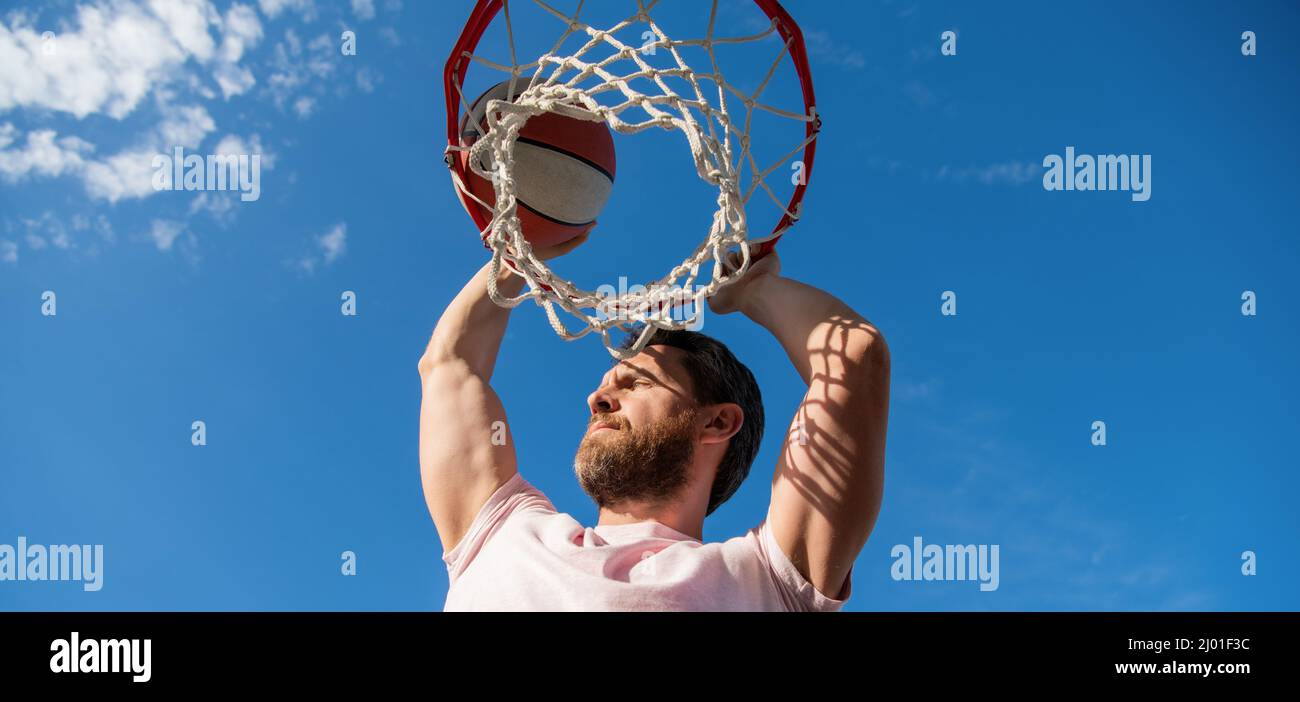 basketball player throws the ball into the hoop outside, sport hobby ...