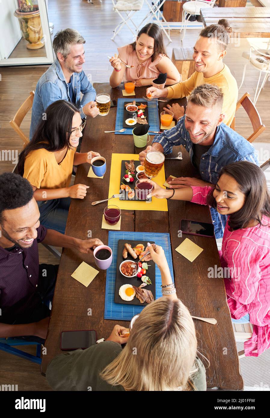 Vertical photo of People having fun at bar. Friends taking lunch time ...
