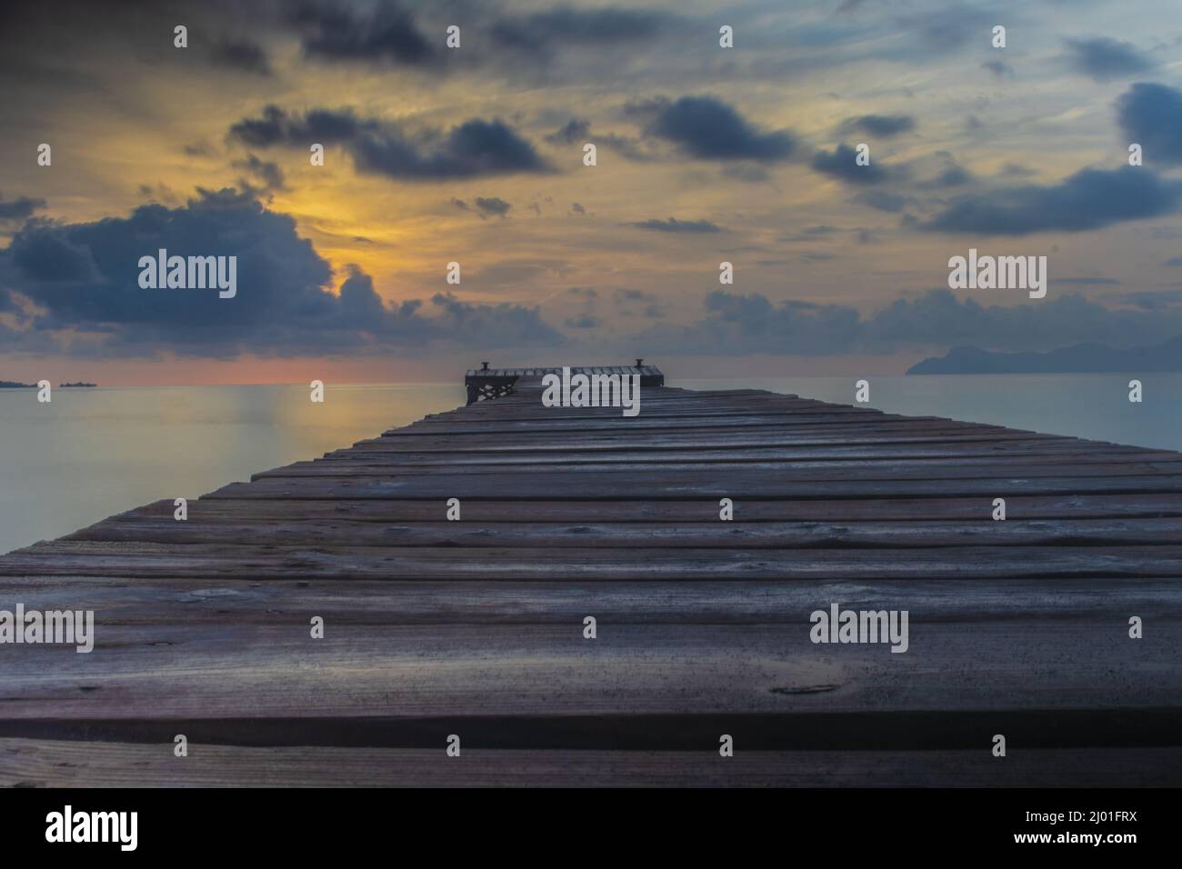 Beautiful sunset sky over a wooden port on a sea Stock Photo - Alamy