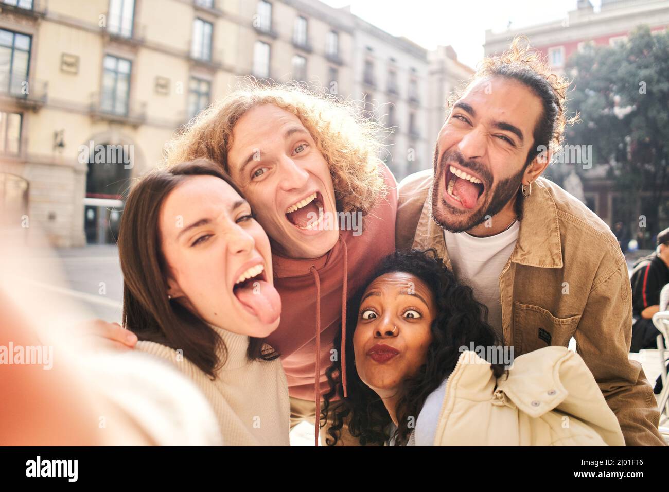 Cheerful young friends taking selfie portrait fool around. Happy people goofing off having fun ...
