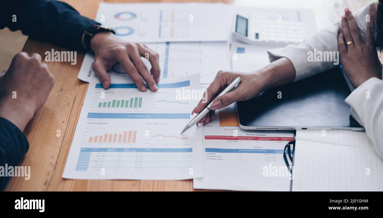 At the office desk, a company team is organizing a successful team ...