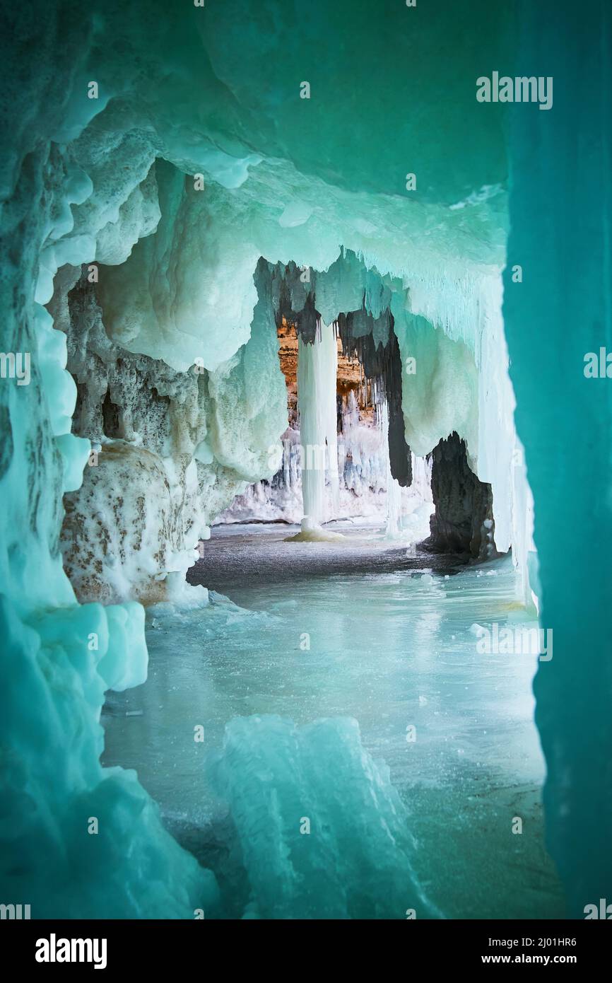 Large icicle in ice cave with vibrant blue and green colors Stock Photo ...