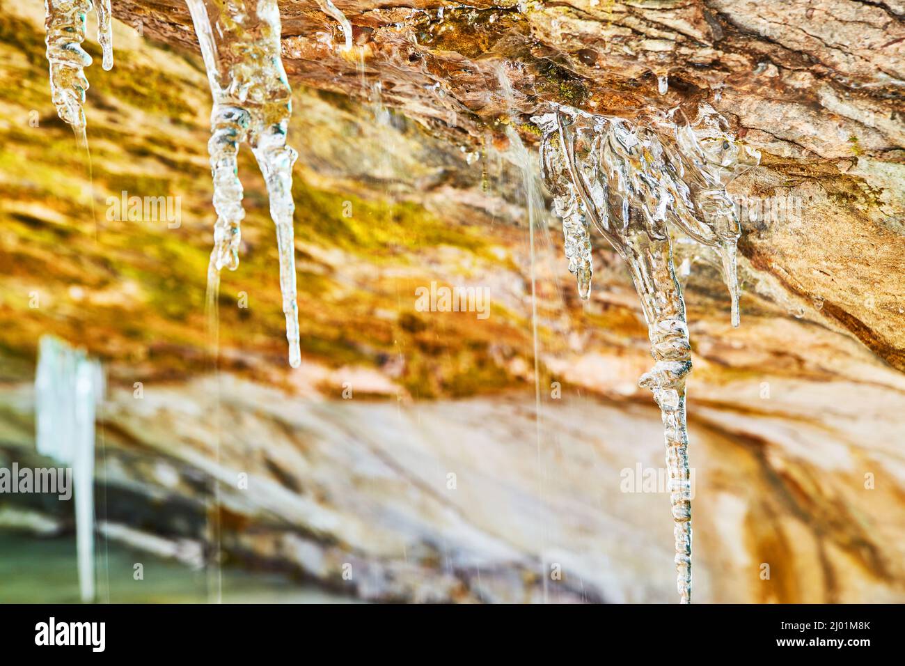 Small melting icicles on rock surface Stock Photo - Alamy