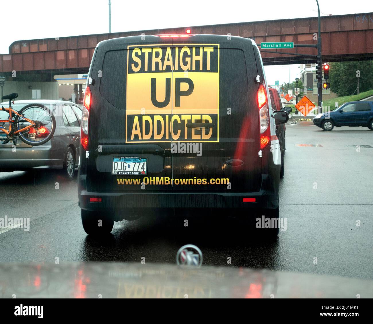 Black van in traffic with sign Straight Up Addicted on back doors. St ...