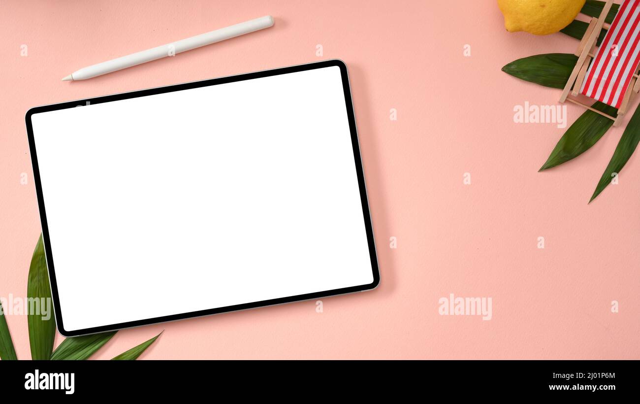 Stylish feminine pink workspace background with digital tablet touchpad ...