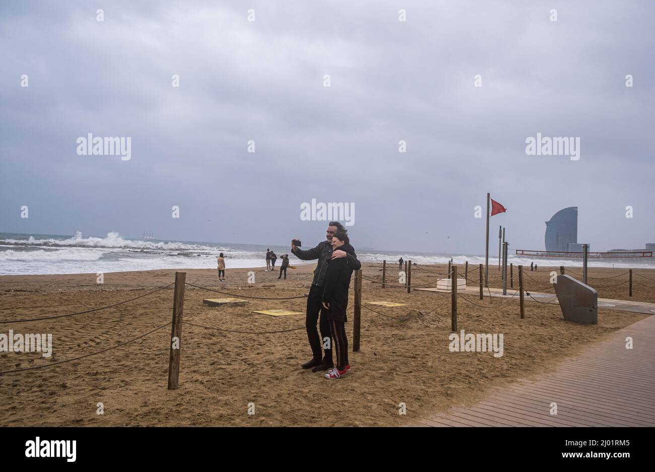 A couple is seen on the beach taking a selfie during the Celia storm ...