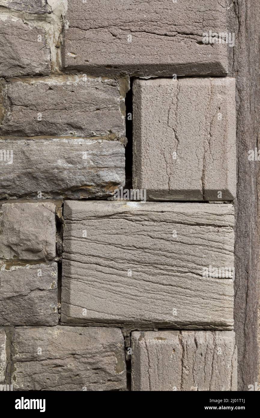 Close-up of loose and cracked mortar joints between grey stones in ...