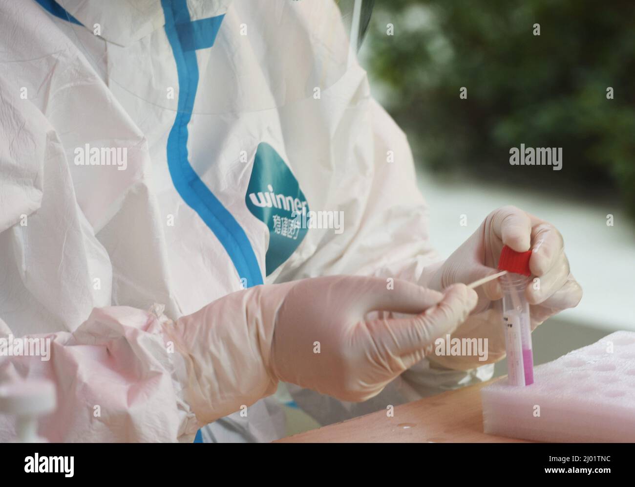 HANGZHOU, CHINA - MARCH 16, 2022 - A medical worker puts nucleic acid ...