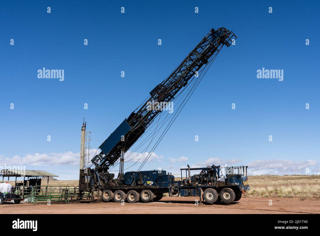 Telescoping truck-mounted workover rig folding up Stock Photo - Alamy