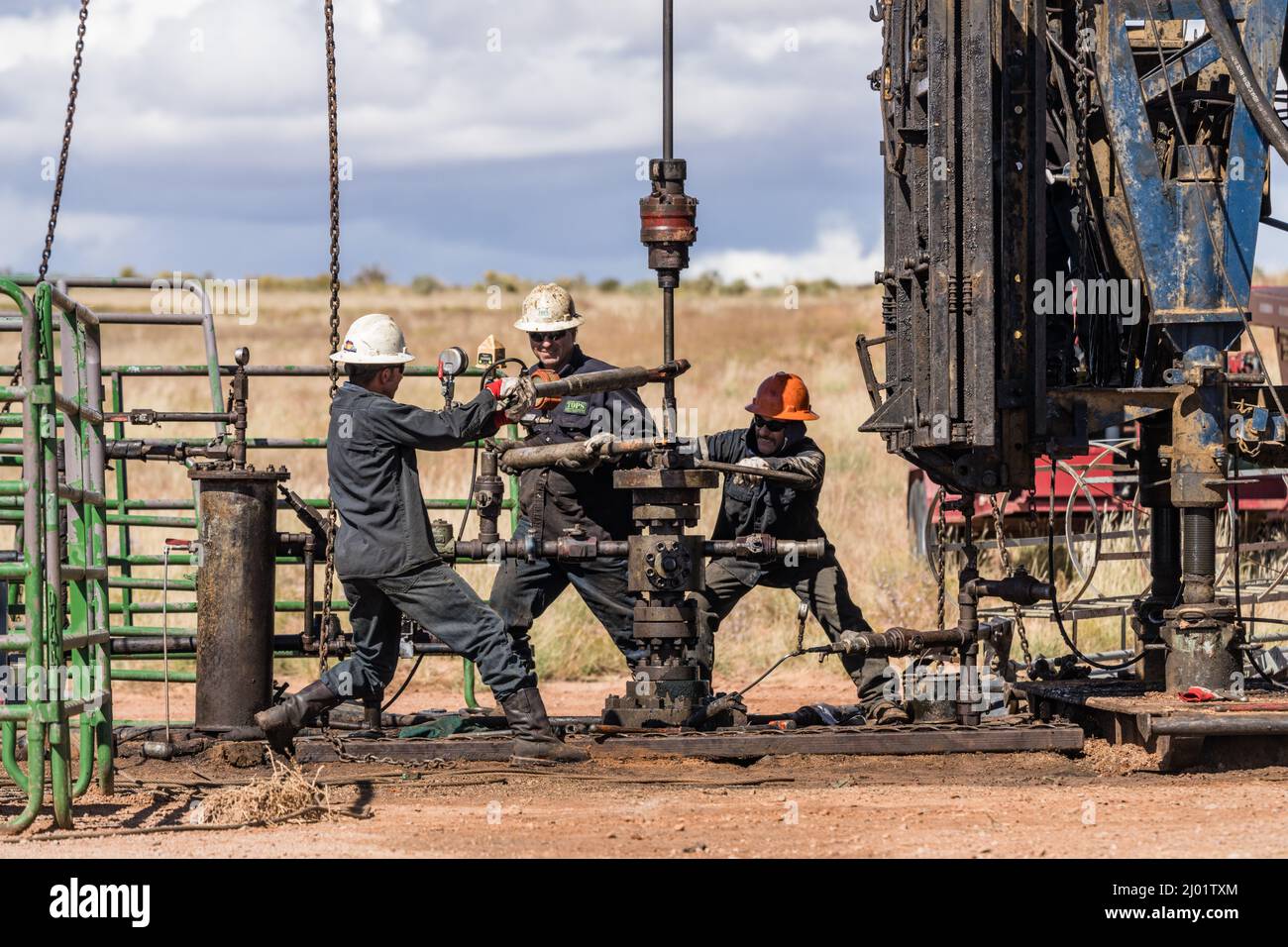 Well service crew on a workover rig Stock Photo - Alamy