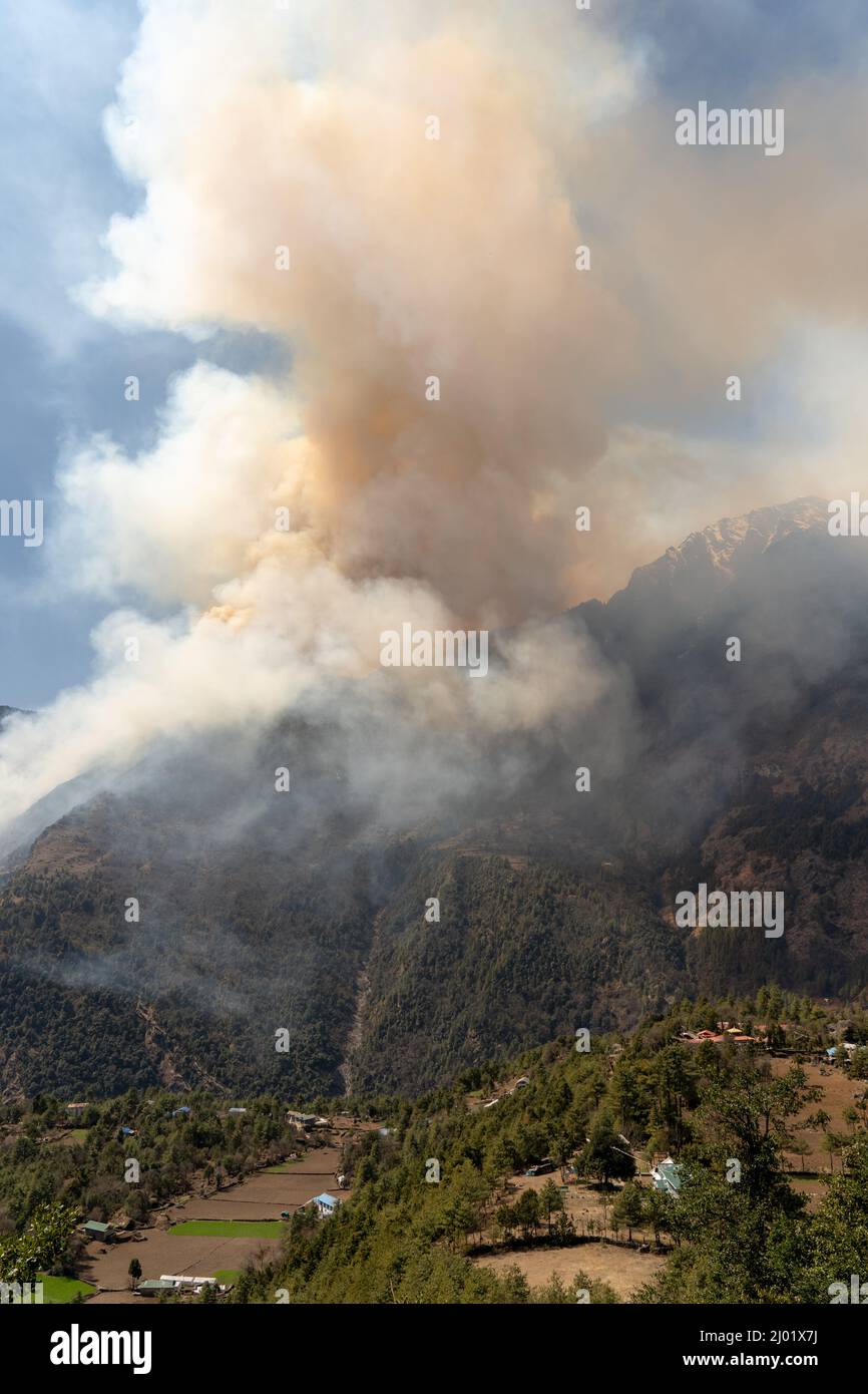 The smoke from a forest fire filling the sky over a mountain in Nepal ...