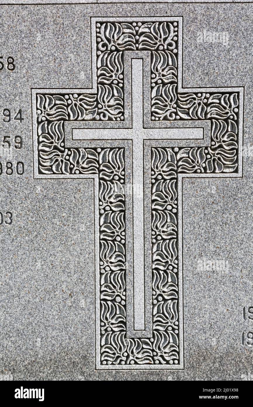 Close-up of carved Christian cross on granite headstone, Montreal ...