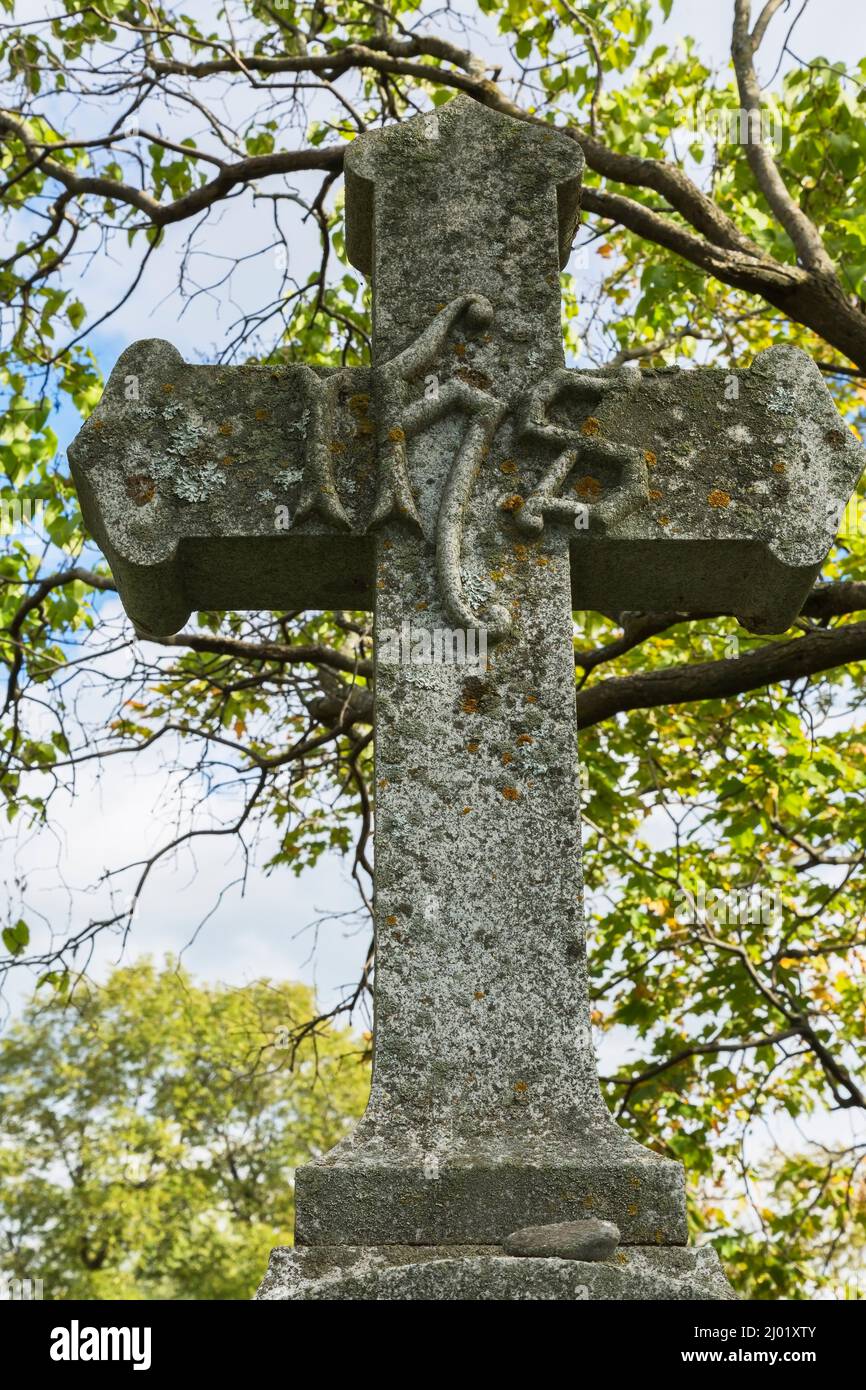 Close-up of weathered granite Christian cross on headstone Stock Photo ...