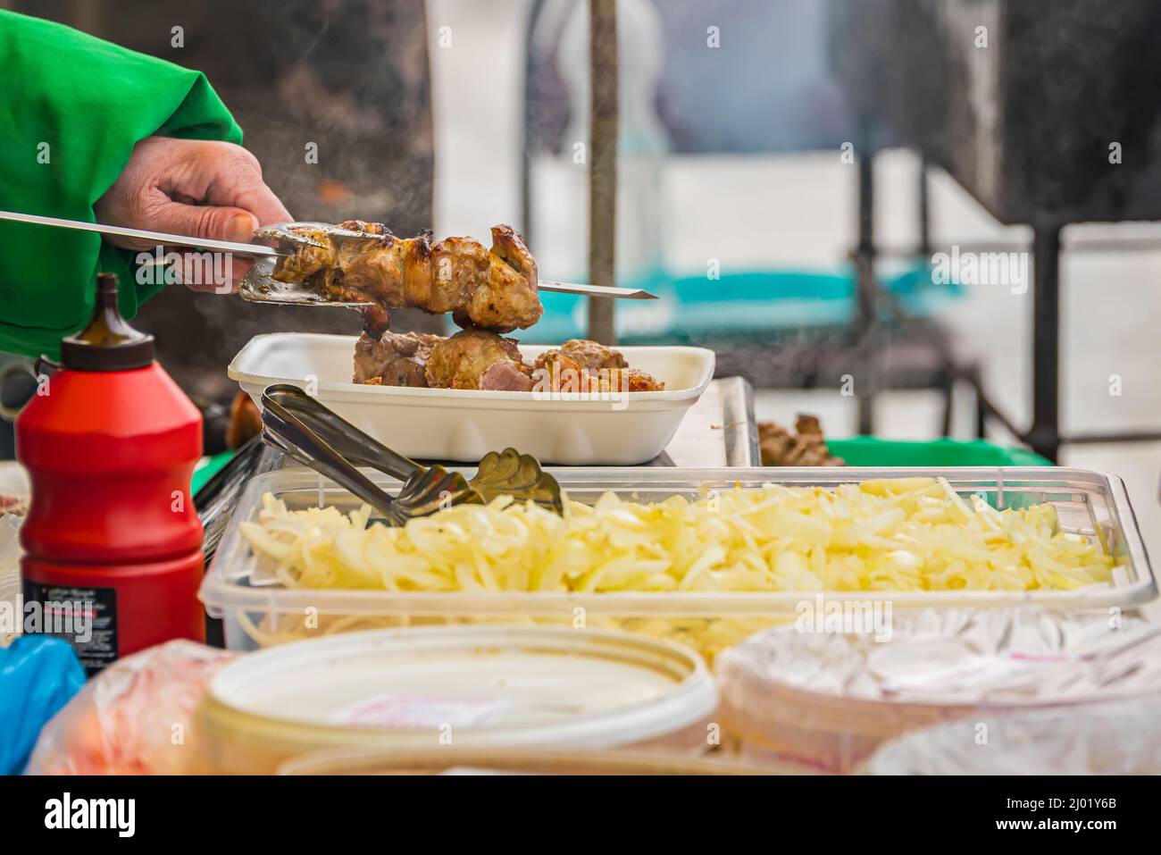 cooking and selling barbecue on the street in the field, hot meat food ...