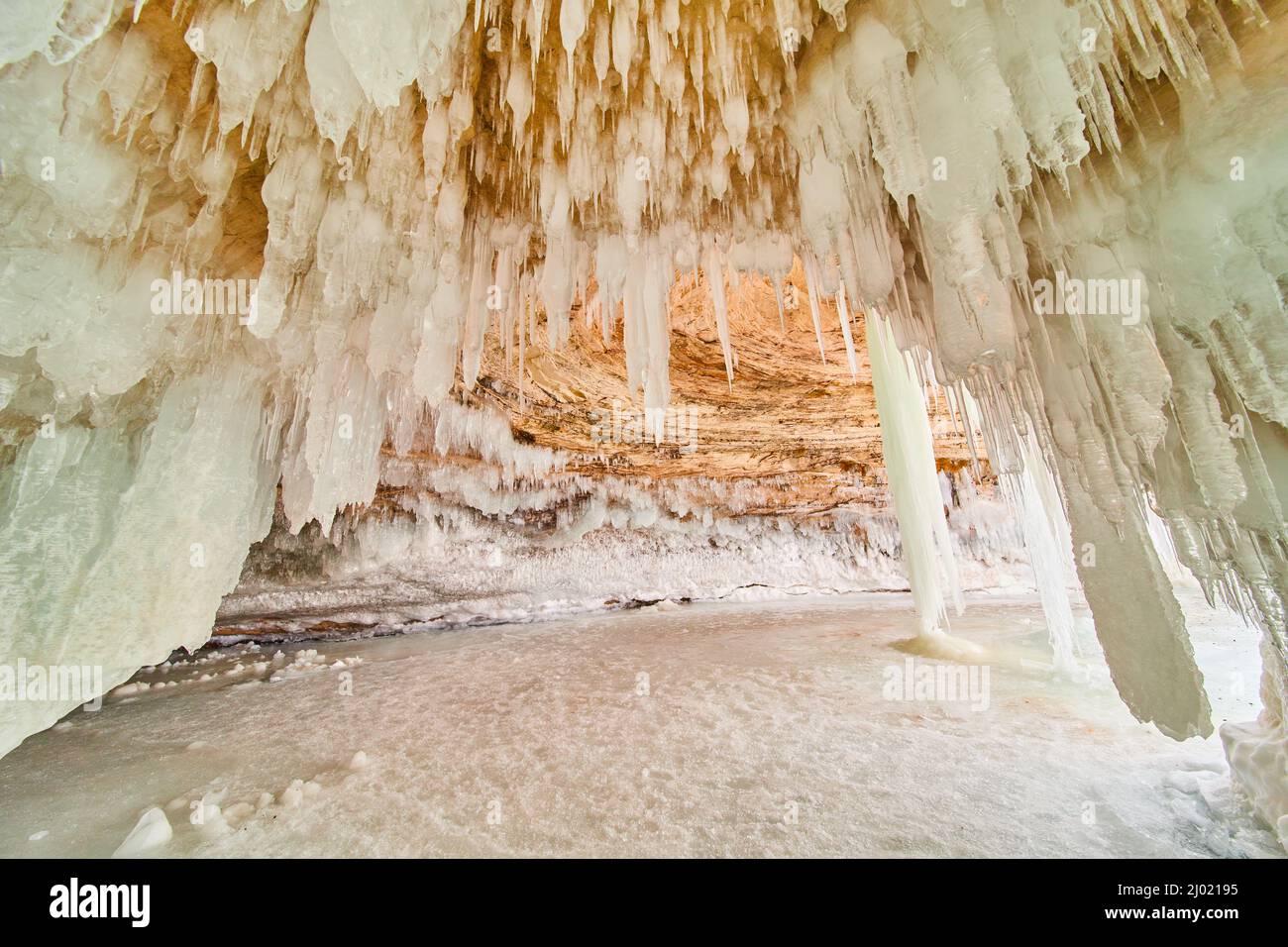 Icicles covering ceiling of rock ice cavern on lake Stock Photo - Alamy