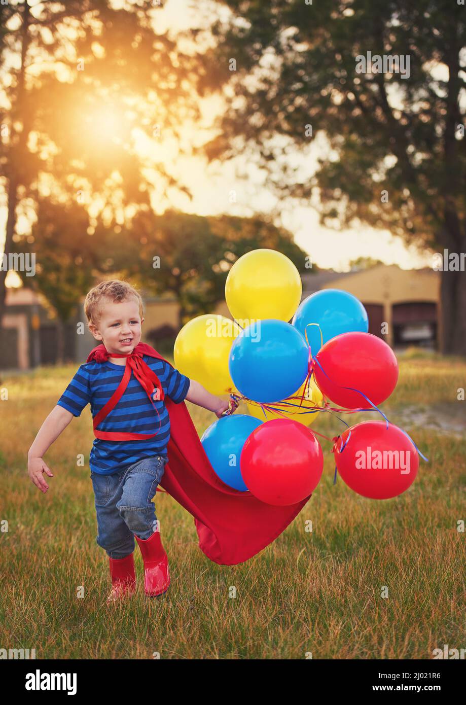Next stop, the moon. Shot of a cute little boy in a superhero costume ...