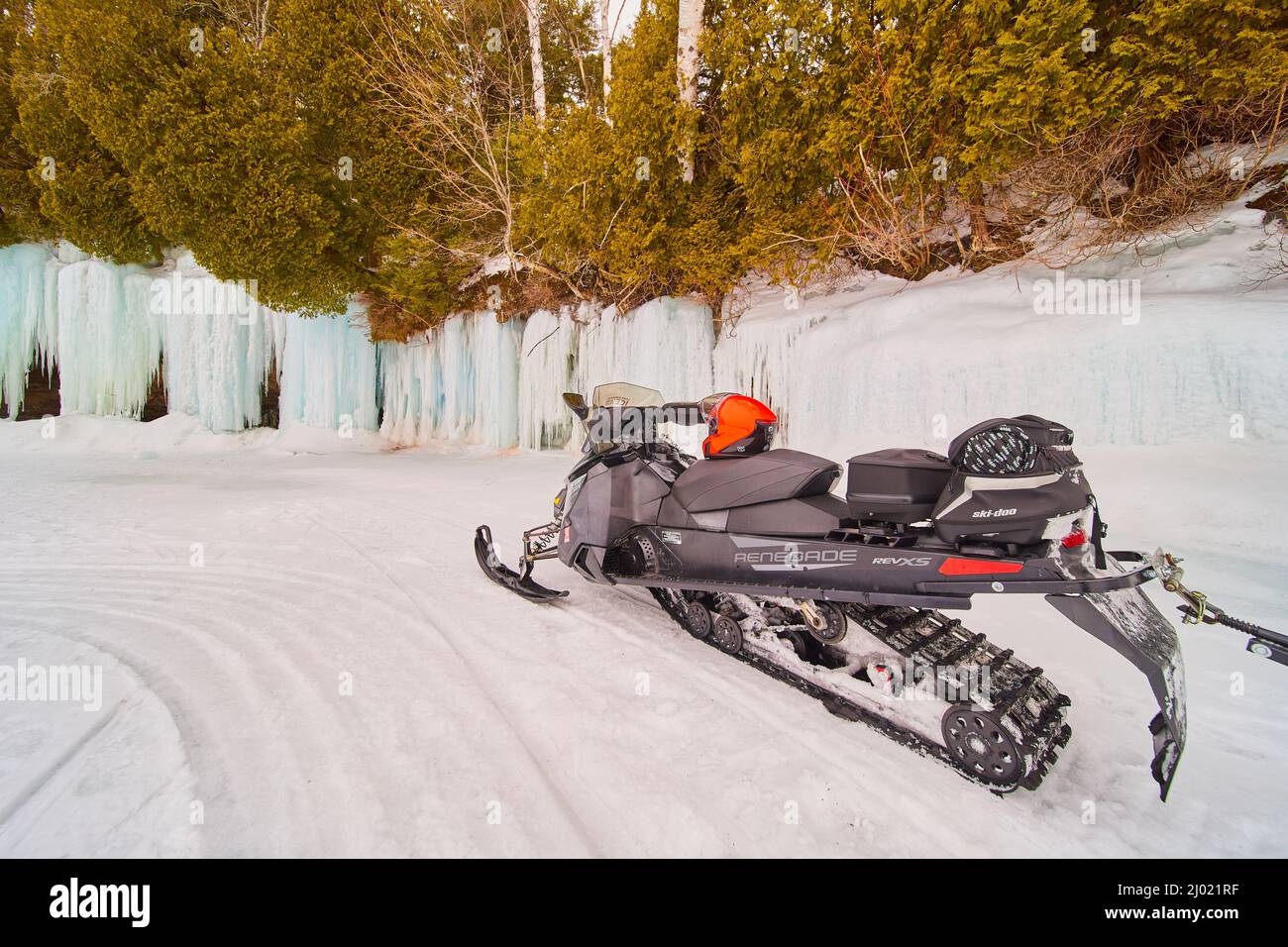 Snow mobile on frozen lake next to ice caves Stock Photo - Alamy