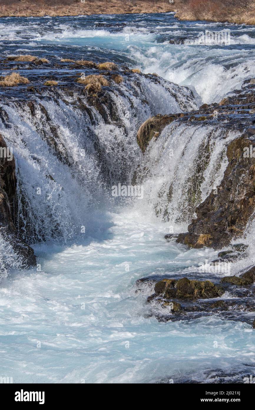 Vertical shot of raging water over rocks in Iceland Stock Photo - Alamy