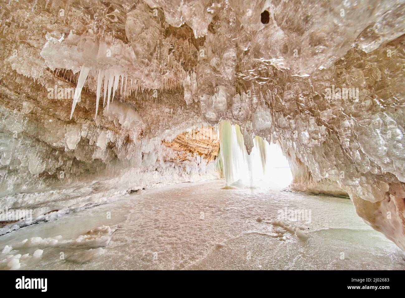 Beautiful pure and clear icicles covering ceiling of ice cave on lake ...