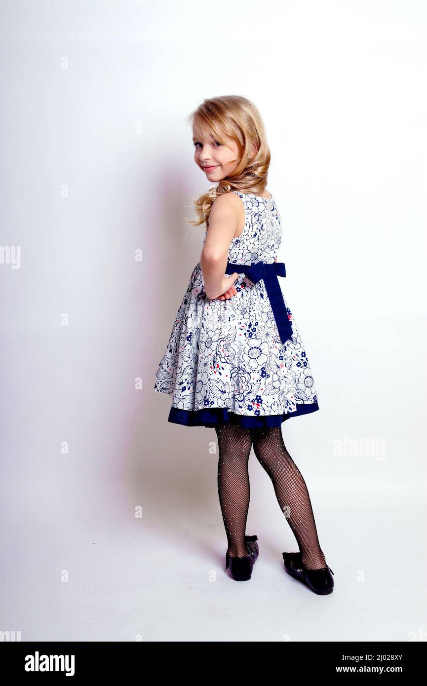 Pretty young kid girl in grey dress.Isolated studio shot Stock Photo ...