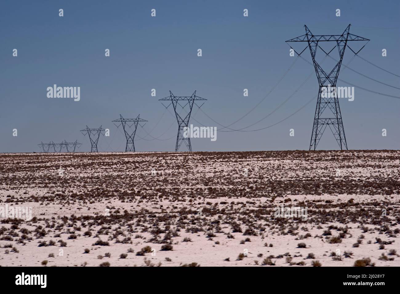 High voltage power lines and towers through desert land of Arizona Stock Photo - Alamy