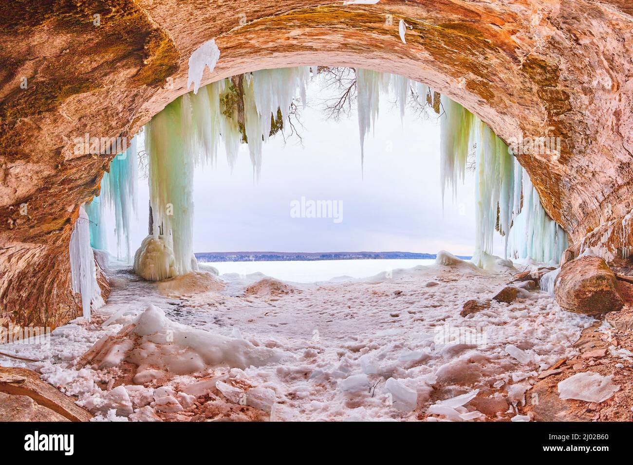 Wide angle frozen ice cave opening with dozens of icicles Stock Photo ...