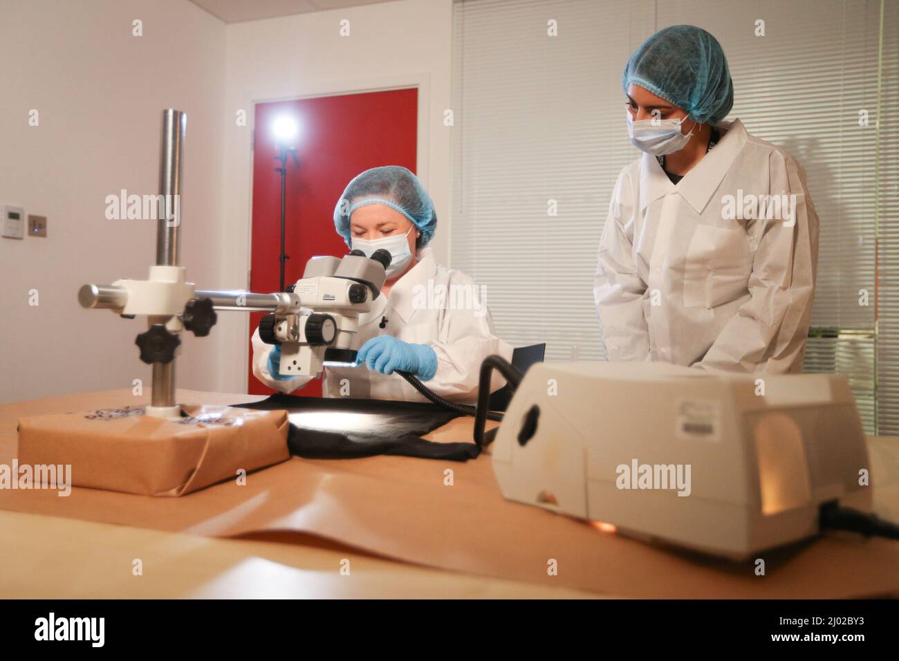 A forensic examiner using the traditional method of blood detection ...