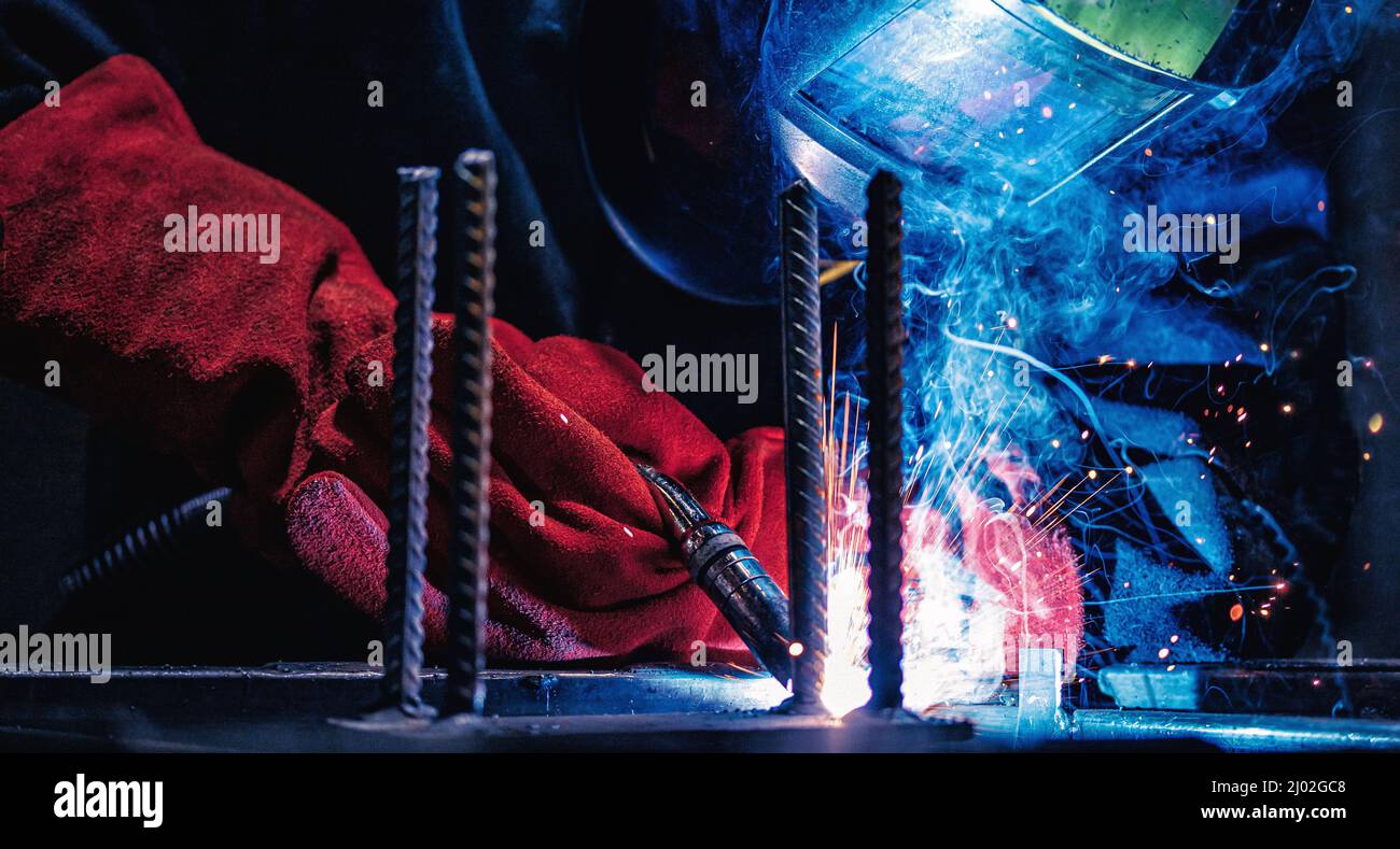 Professional welder erecting metal steel. Banner Factory industrial ...