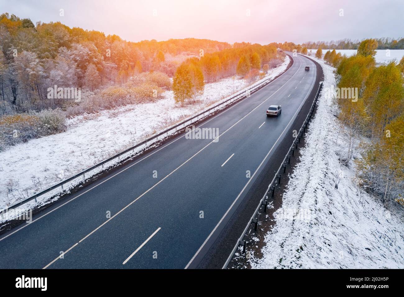 Cars rides winter road through forest, trees with snow. Sunlight ...