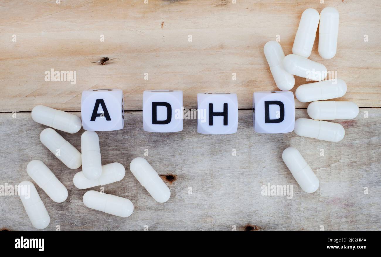 ADHD in letter dice on a rustic and natural wood with copy space ADHD ...