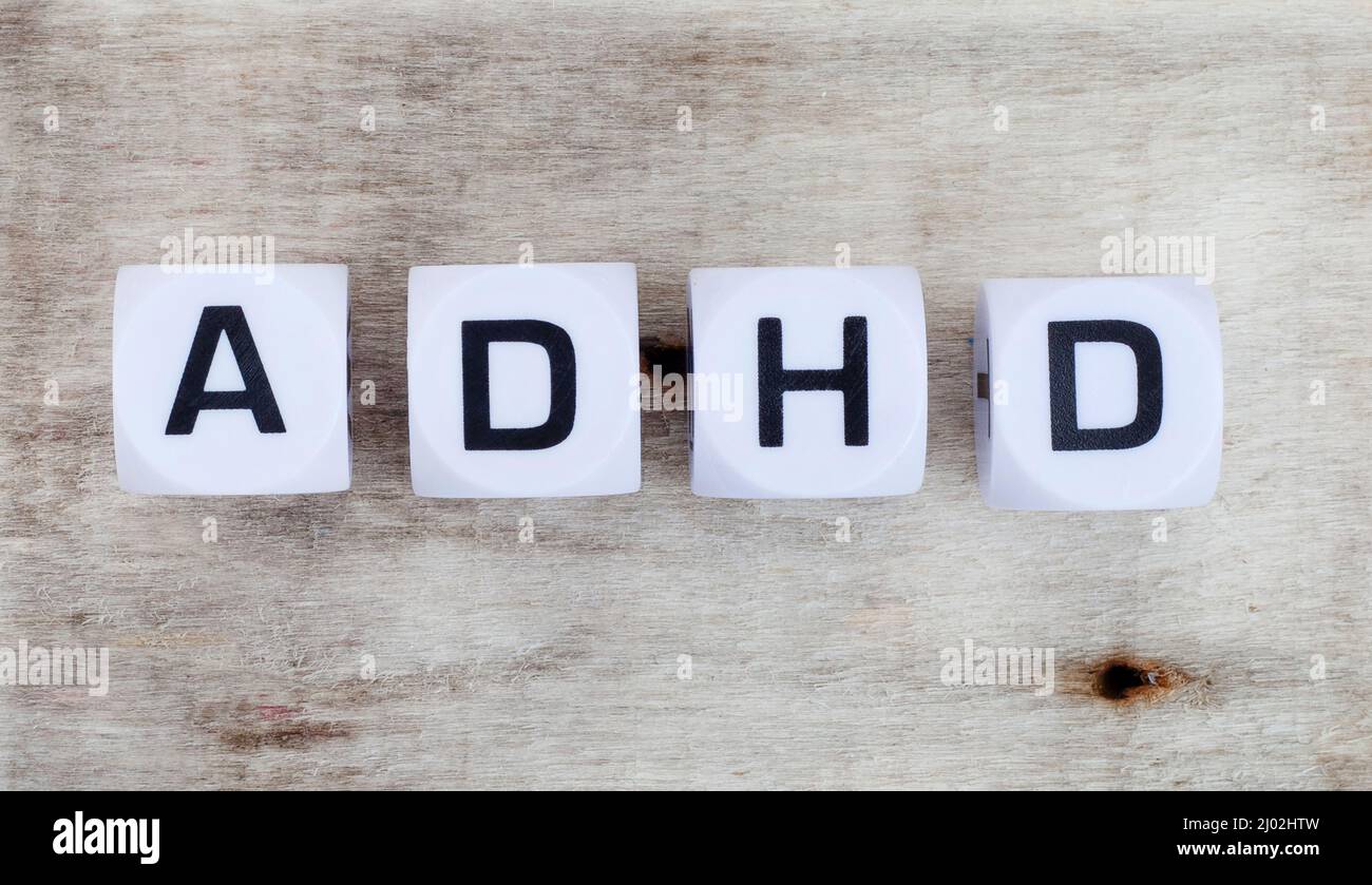 ADHD in letter dice on a rustic and natural wood with copy space ADHD ...