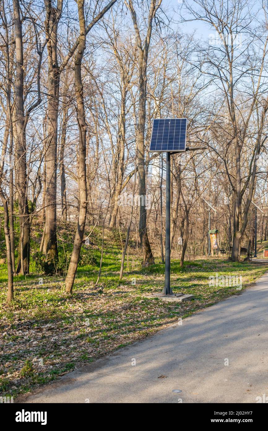 Sunny day on the promenade in the city park Kamenica, Novi Sad. Solar ...