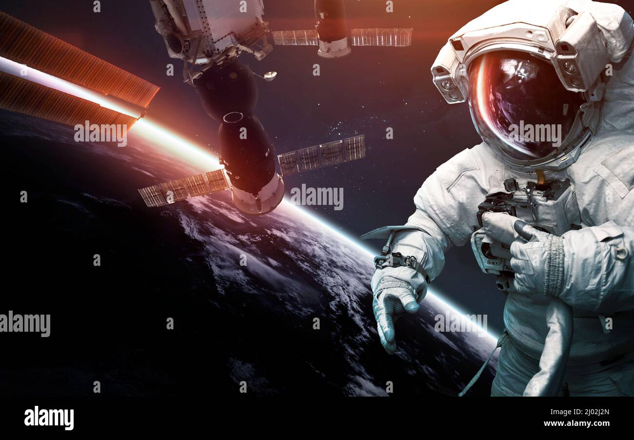Astronaut at spacewalk against international space station. Science ...