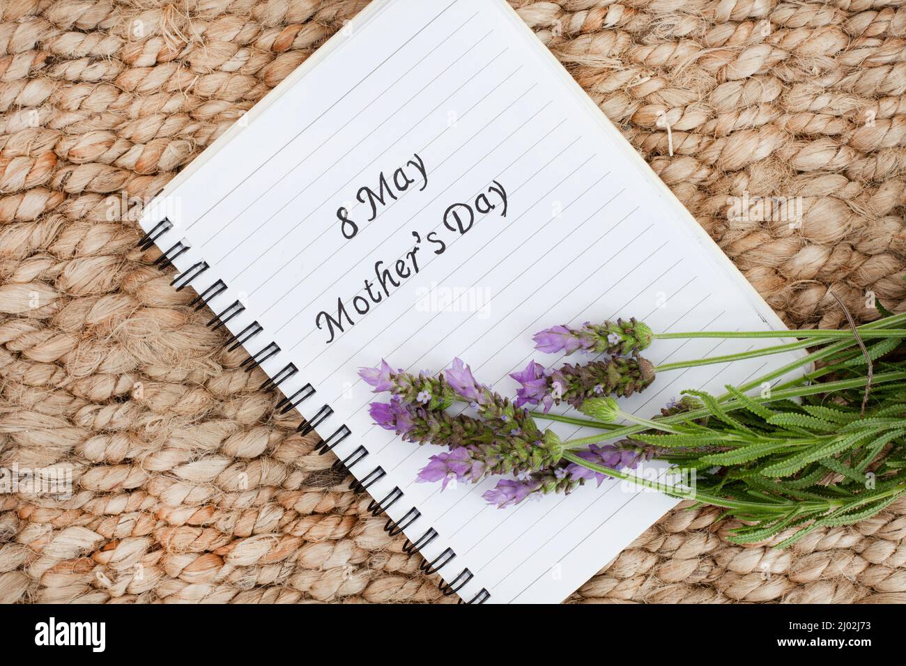 8 May Mother's Day written on notebook page with rustic backdrop Stock ...