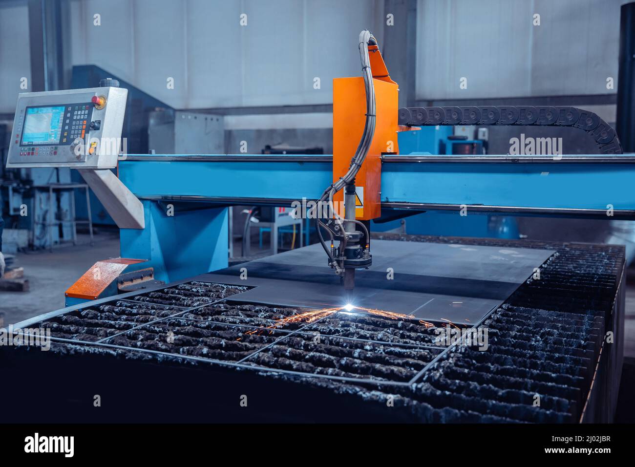 Plasma cutting CNC machine cuts metal material with sparks, industry ...
