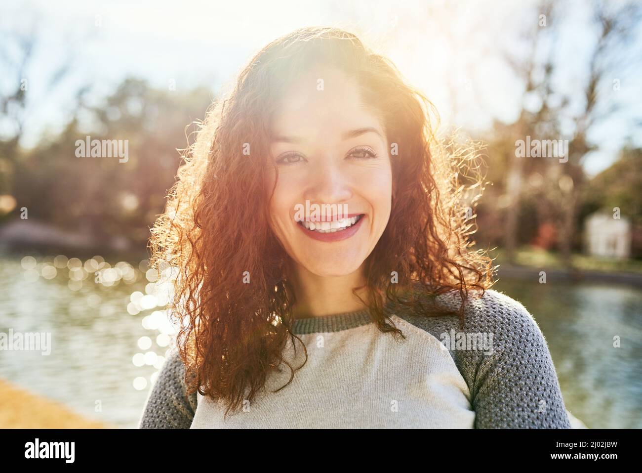 The summer sun is why I love the outdoors. Portrait of a beautiful ...