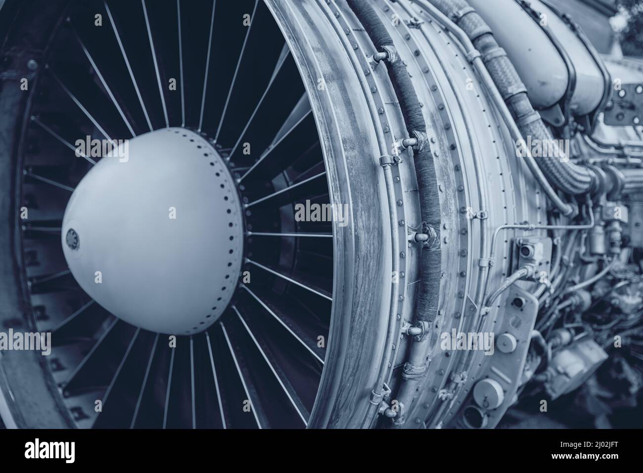 Closeup detail of turbine airplane engine blades, toning blue color ...