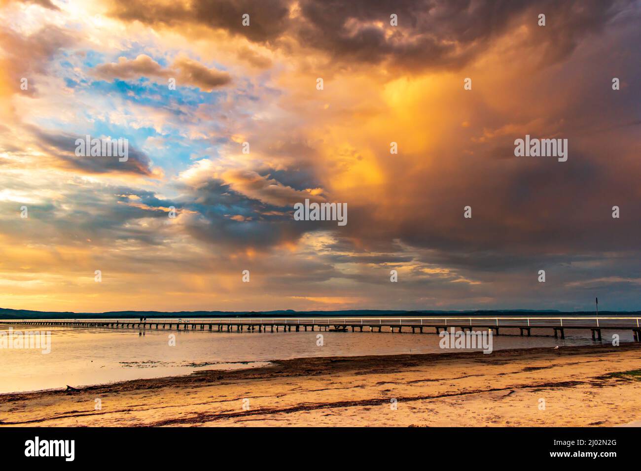 Sunset by the pier Stock Photo - Alamy