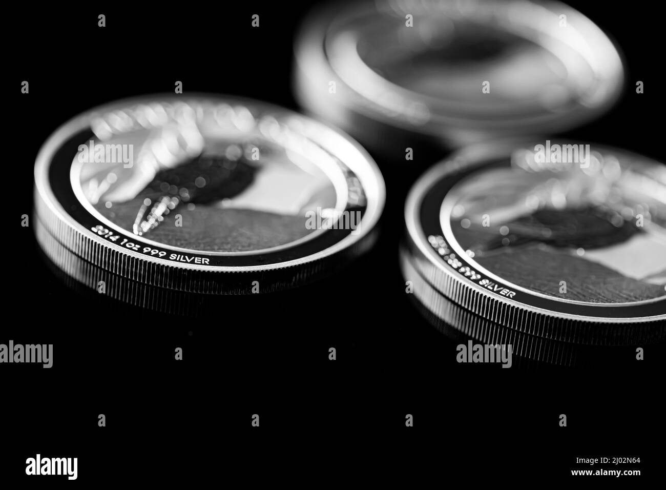 Macro Close up of Silver Bullion Coin on a black mirror background ...