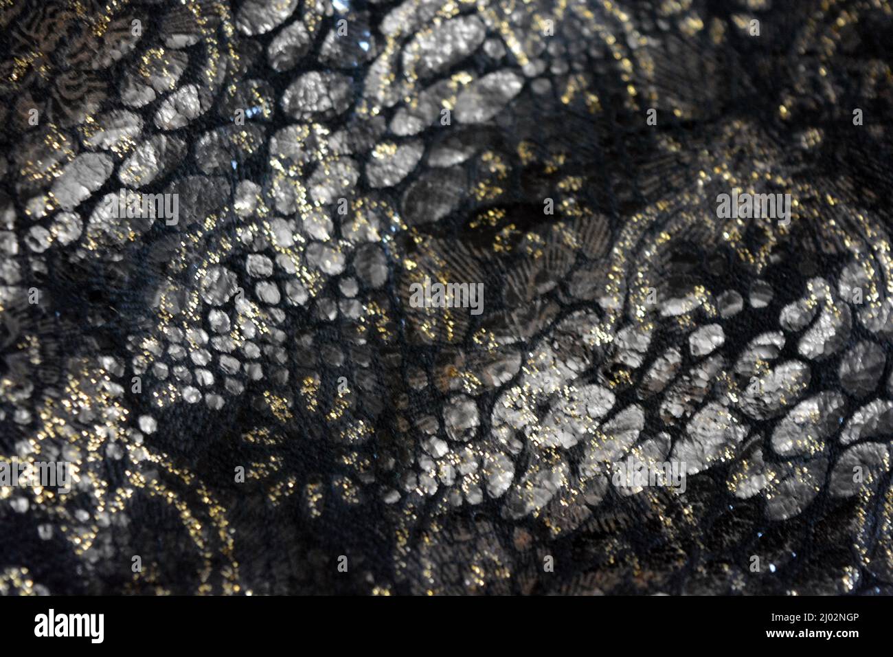 Black dark fabric background with gilding, gold flower patterns with ...