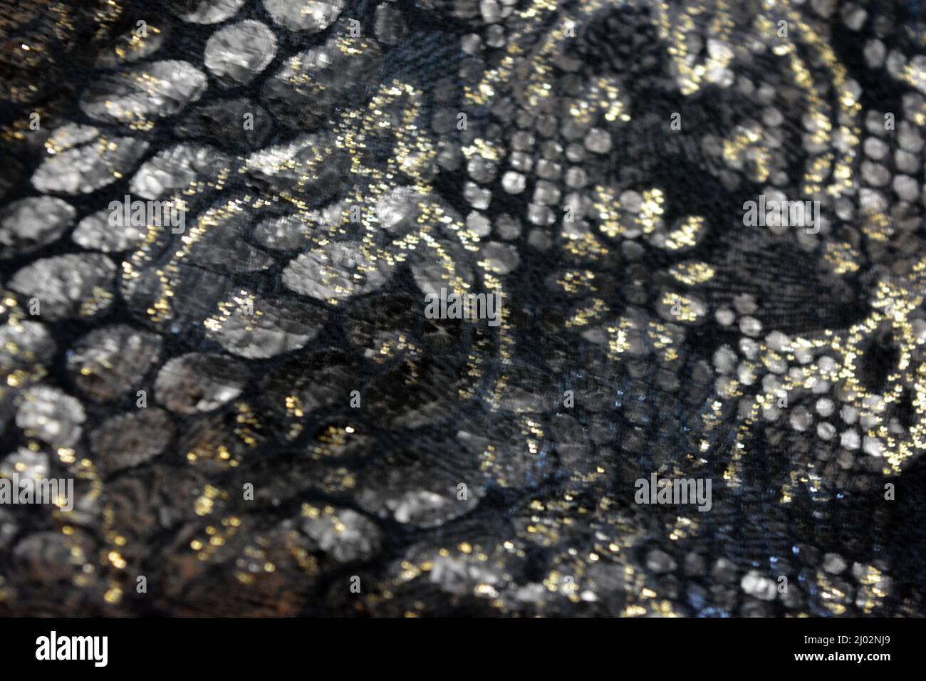 Black dark fabric background with gilding, gold flower patterns with ...